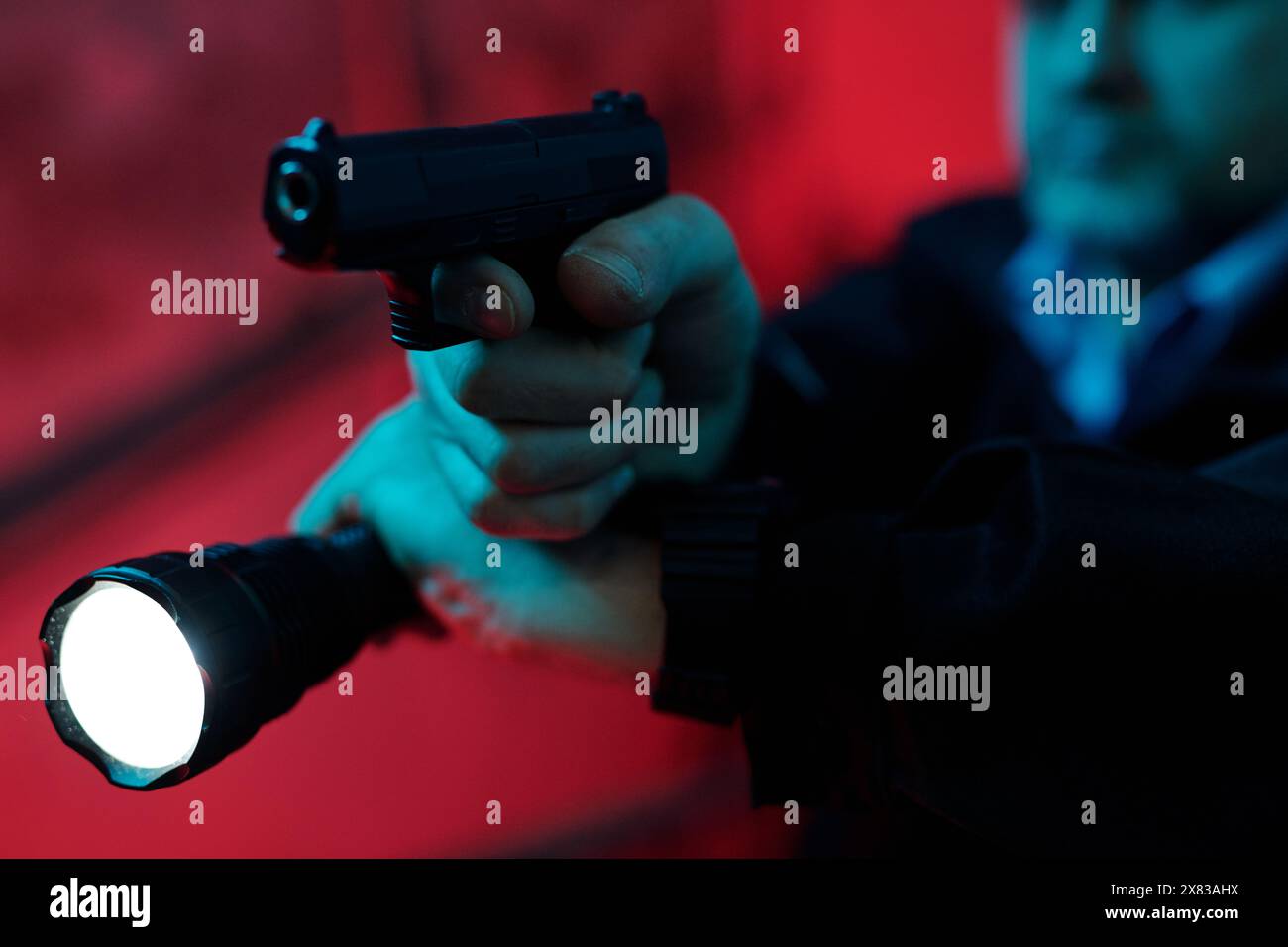 Hand of professional security guard keeping forefinger on gun trigger ...