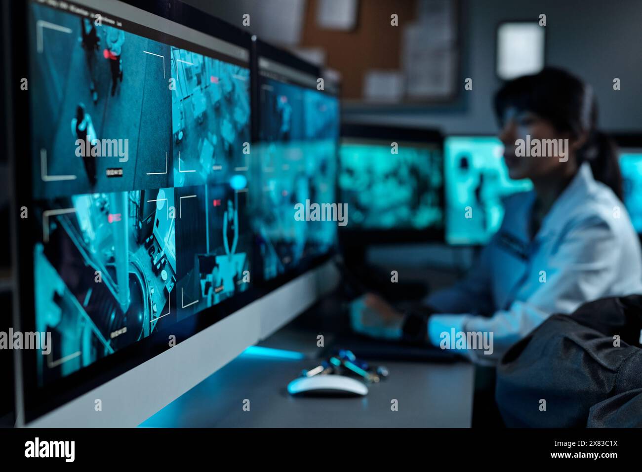 Focus on one of several computer screens with cctv video on workplace ...