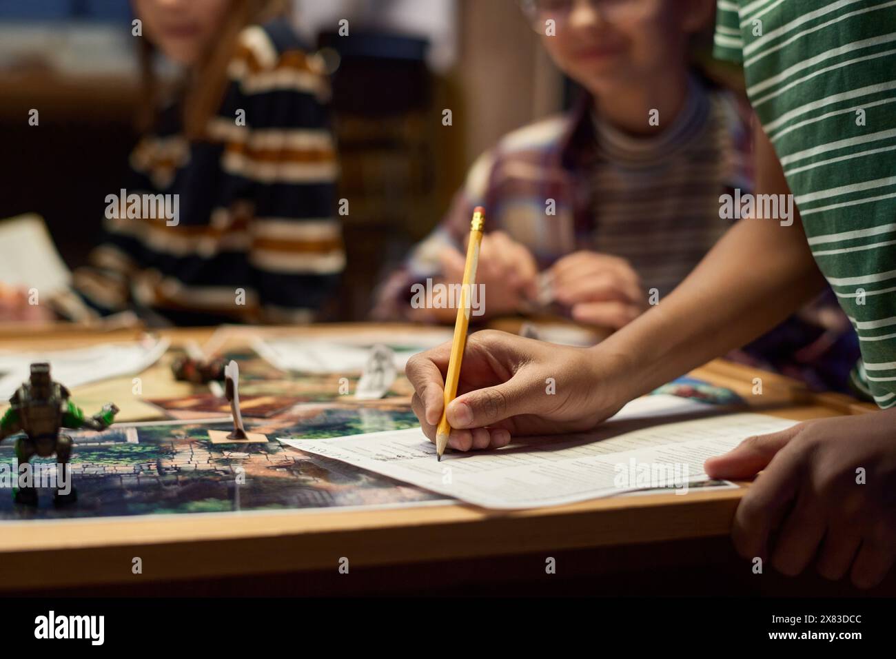 Hands of youngster pointing at paper with board game rules and ticking ...