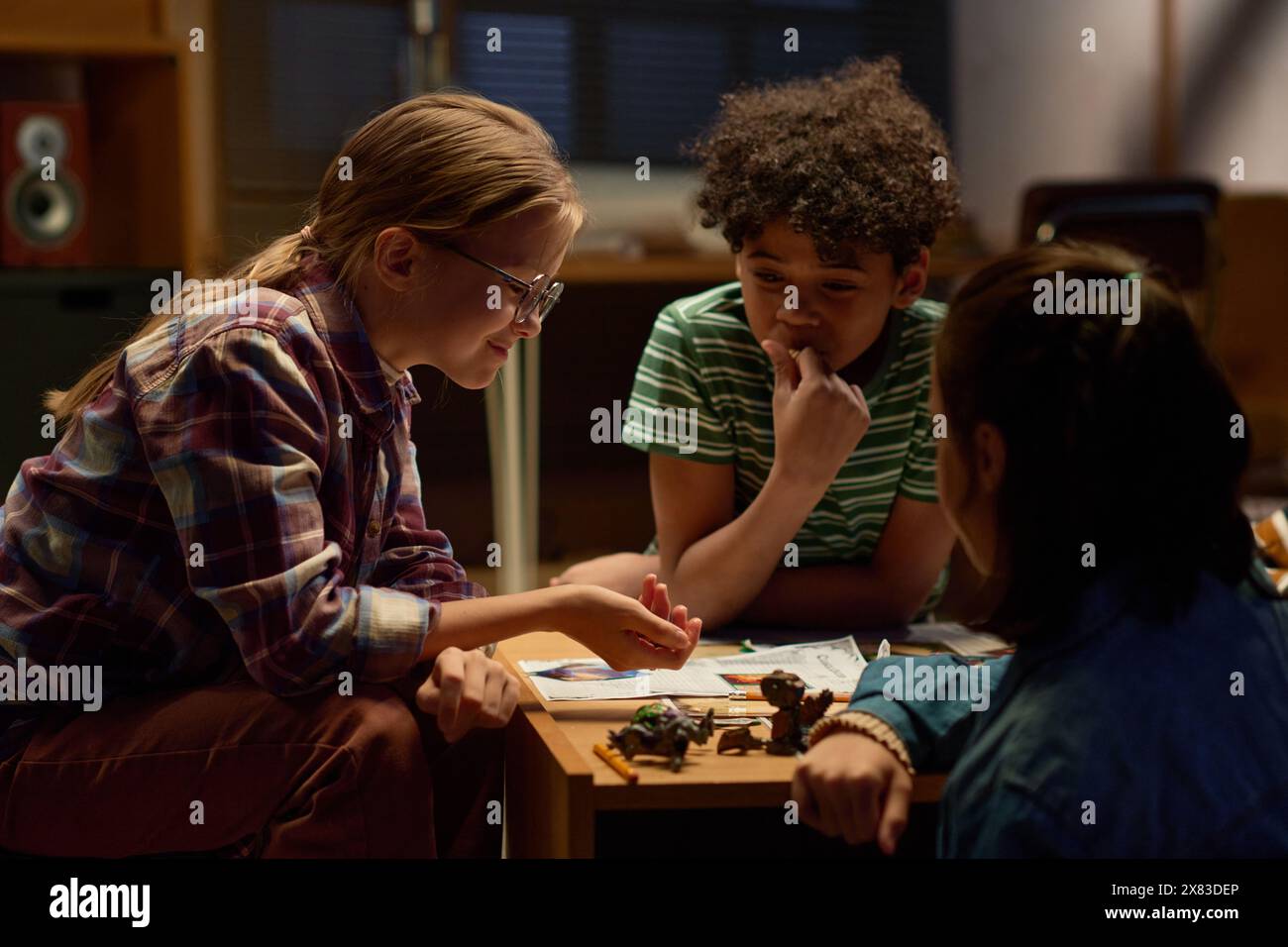 Group of youthful intercultural children in casualwear bending over ...