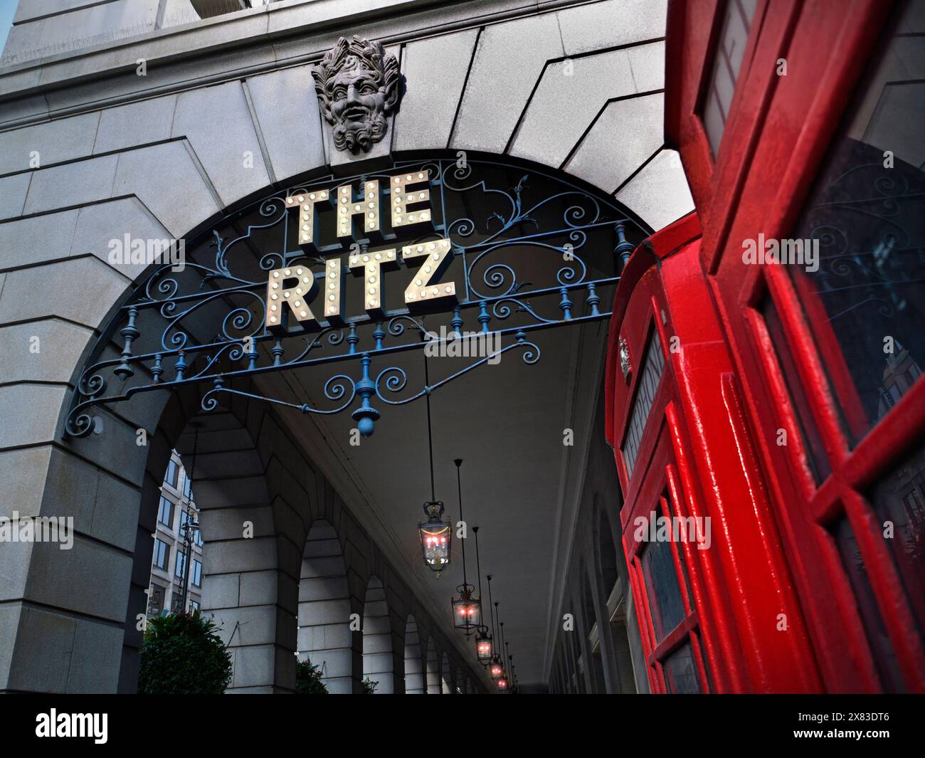 The Ritz Hotel Piccadilly with illuminated sign and traditional red ...