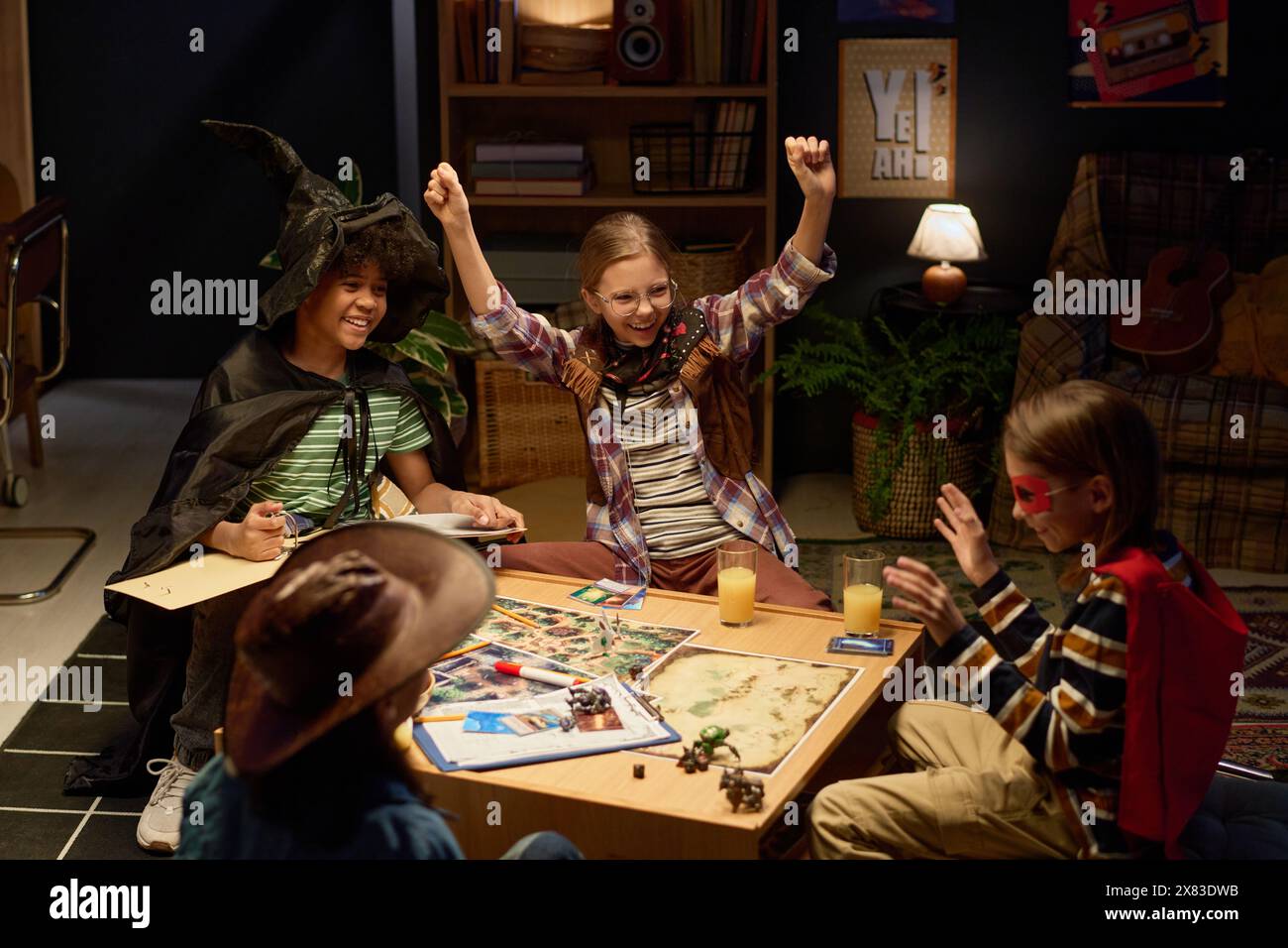 Two ecstatic kids in costumes of their characters raising hands and ...