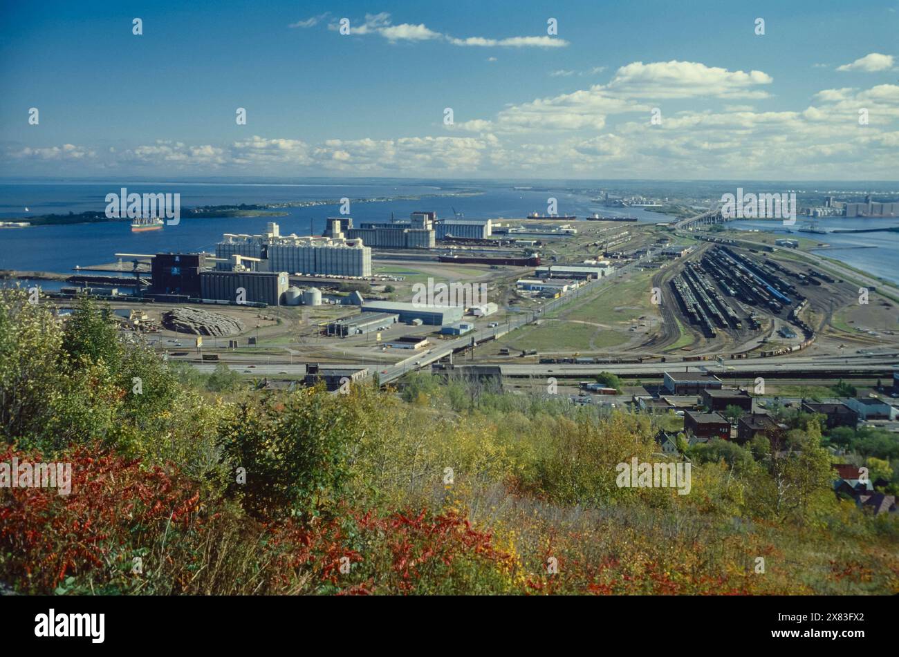 Elevated view of Duluth MN grain elevators, harbor and train yards with ...