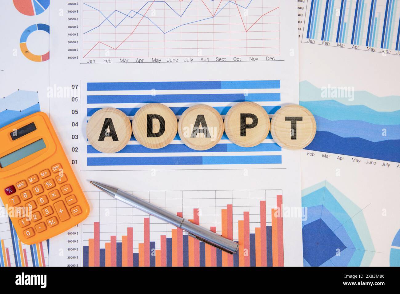 TIME TO ADAPT word on pink paper with office tools on white background ...