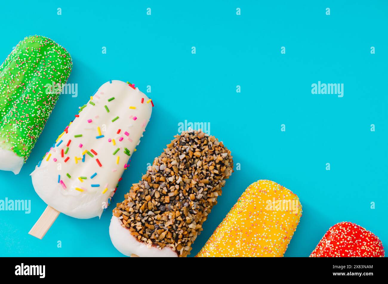 Summer composition of colorful ice cream popsicles on bright blue ...