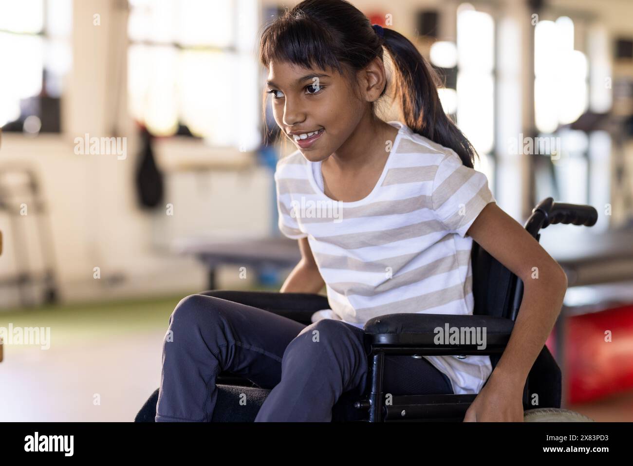 At rehabilitation center, biracial girl with cerebral palsy patient in ...