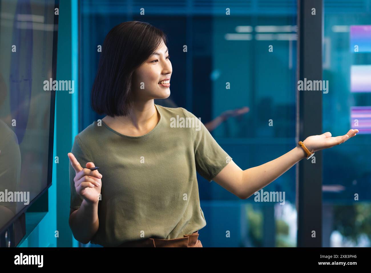 At modern office for business, young Asian woman presenting, pointing ...