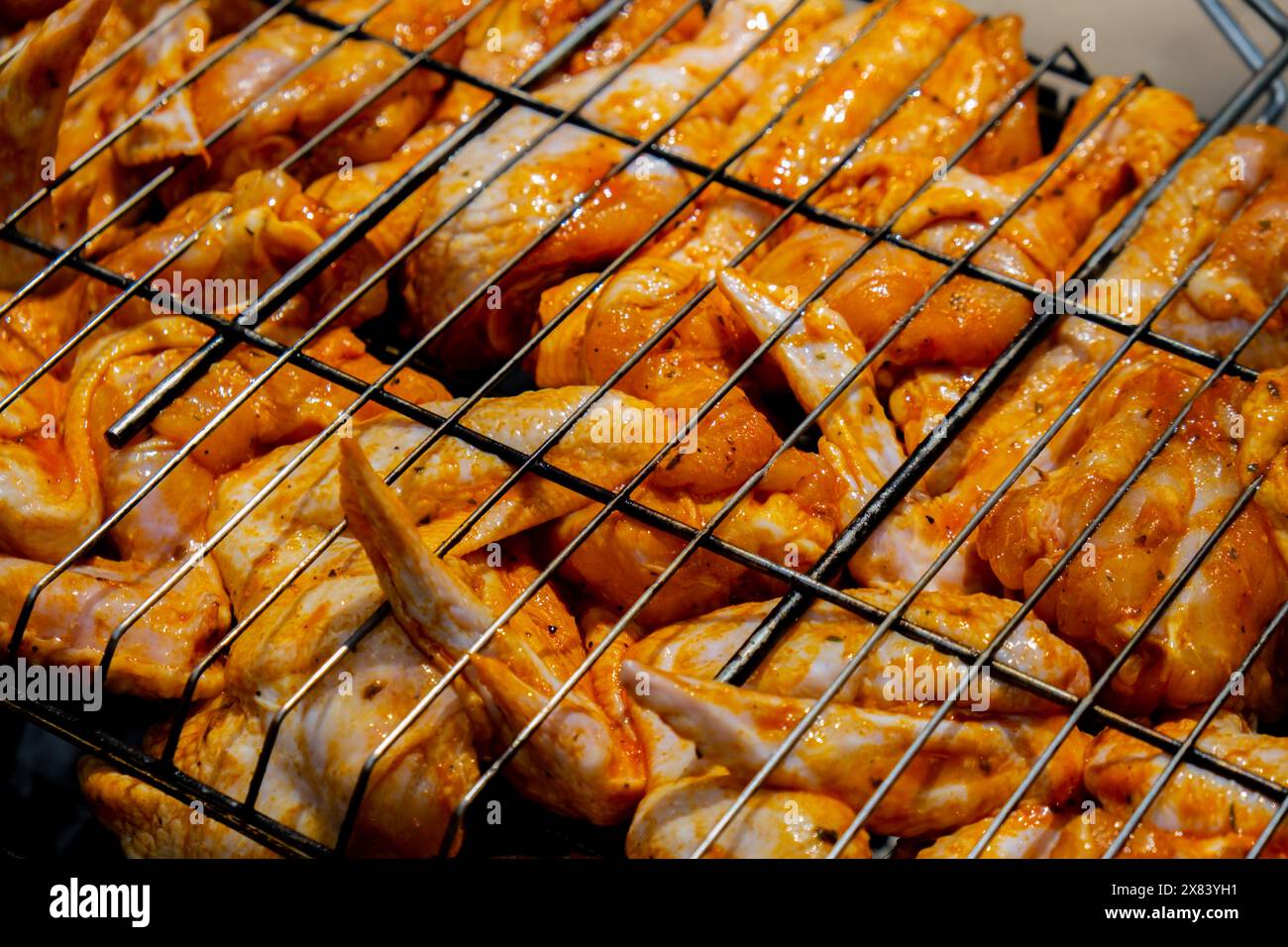 Delicious chicken frying on barbecue grill grate outdoor. Seasoning ...