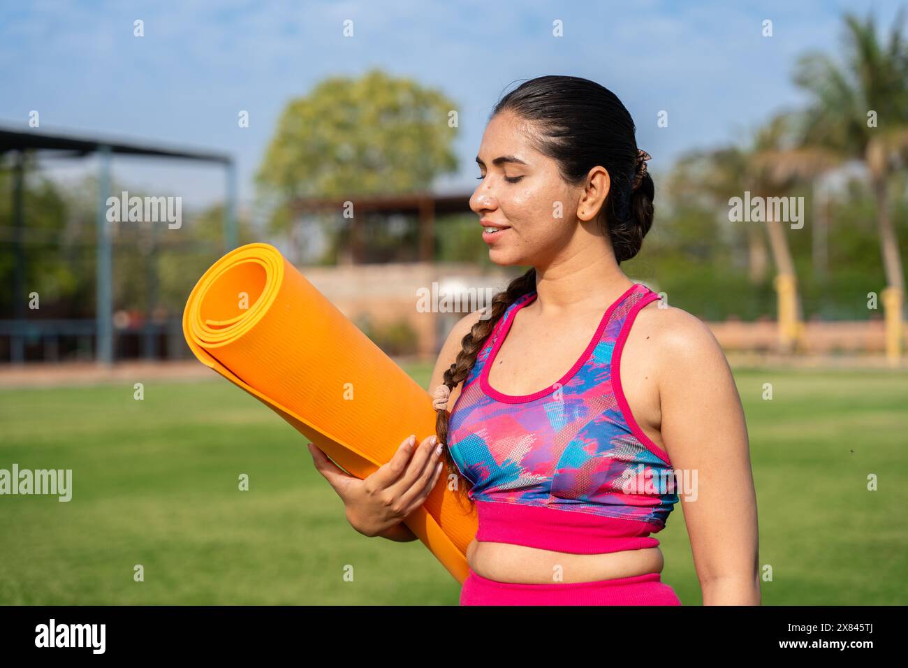 Sporty young indian girl with yoga mat. exercise, meditation for ...