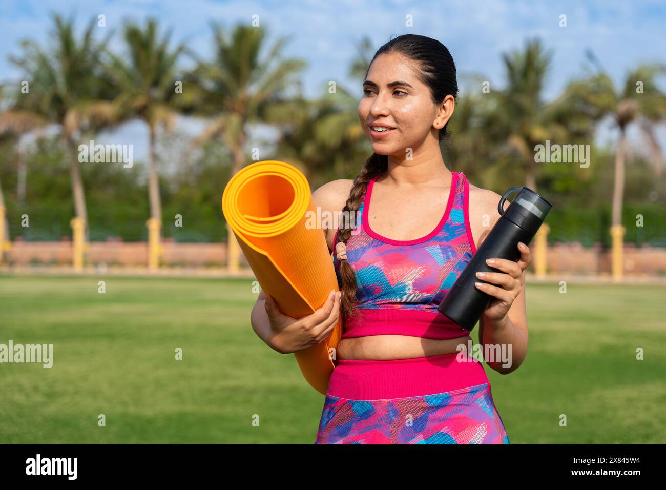 young indian fitness woman with yoga mat, bottle & shaker. exercise ...
