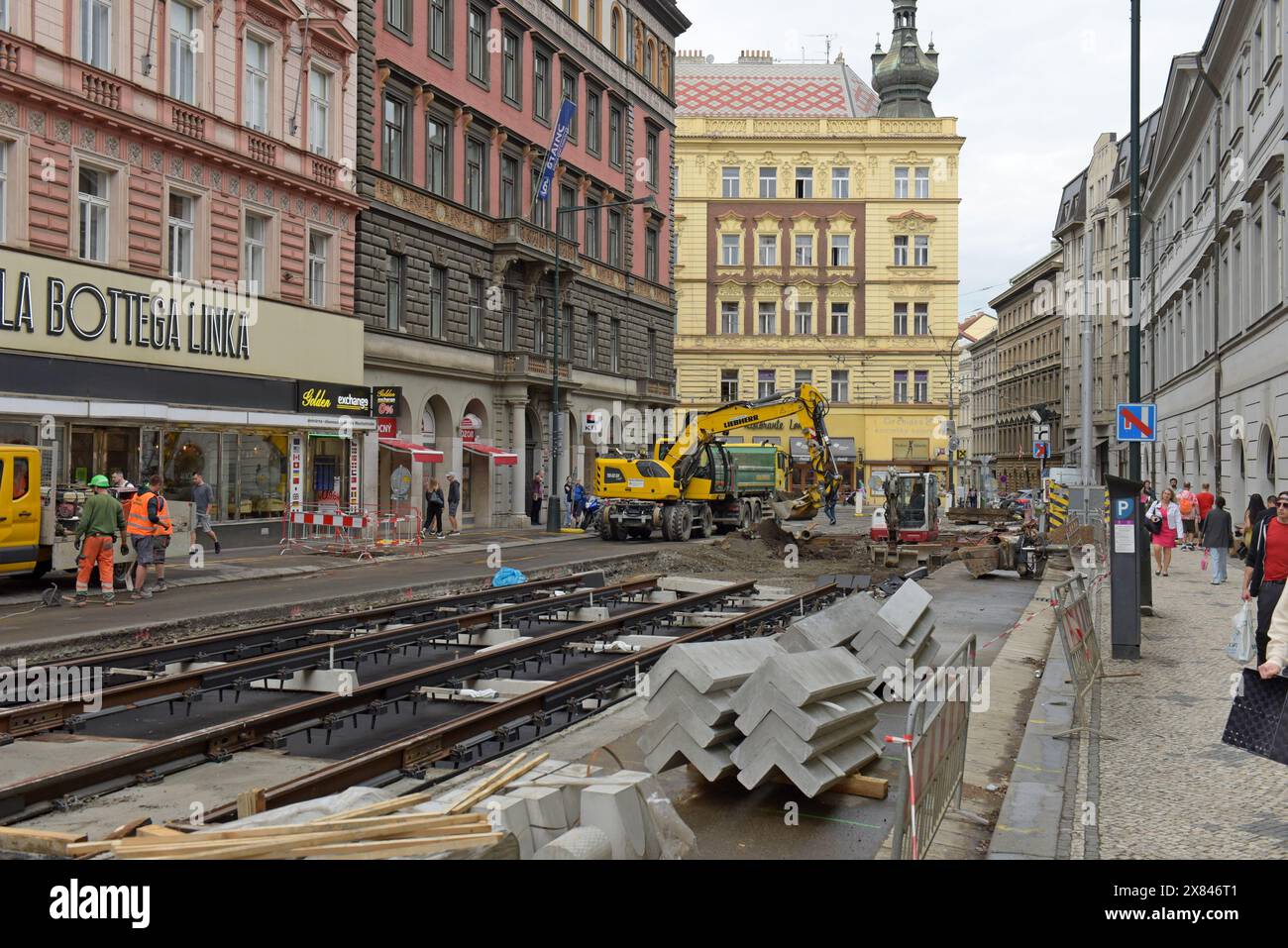 Construction workers relaying tram railway tracks in the street at Senovážné náměstí, Prague ...