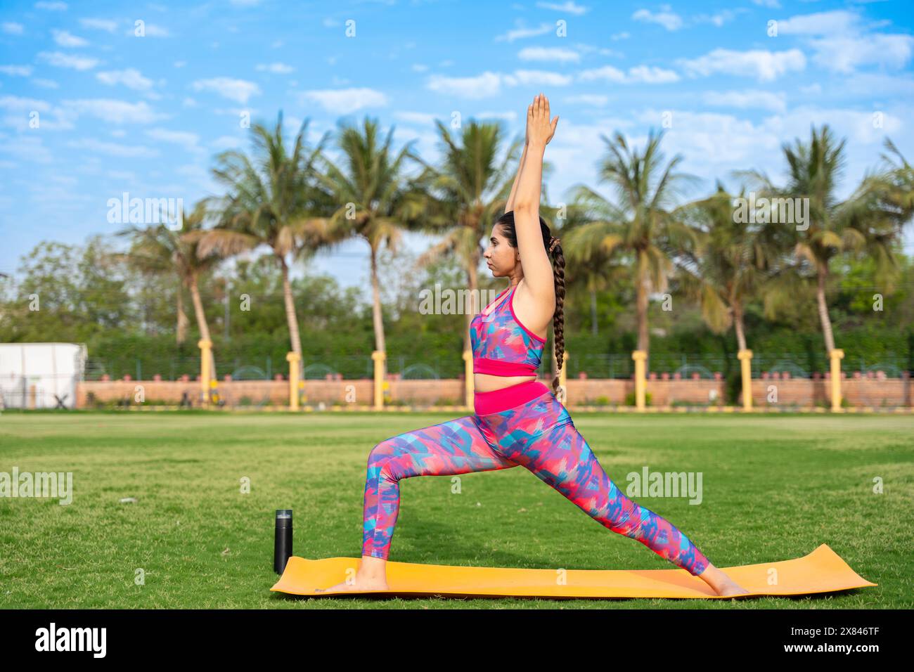 fit young indian girl doing Surya Namaskar or Sun Salutation yoga pose ...