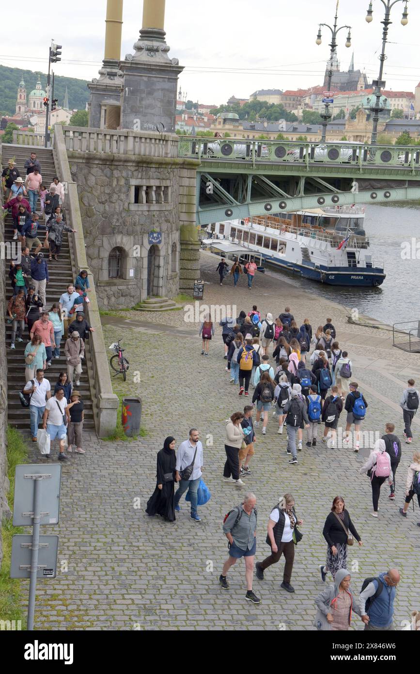 Tourist groups crowd steps next to Čechův Most or Svatopluk Čech bridge ...