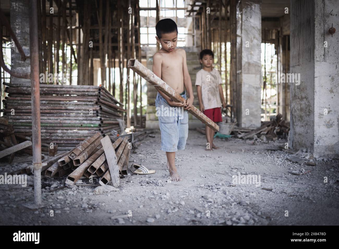 Two poor children are forced to work in construction. Poor children ...