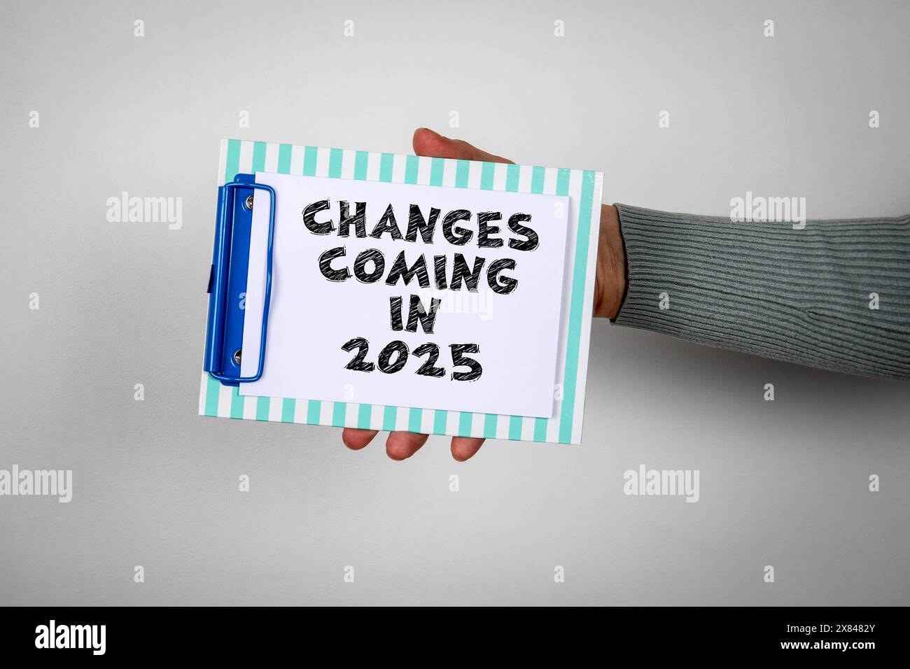 Changes coming in 2025. Paper with a text in a woman's hand Stock Photo ...