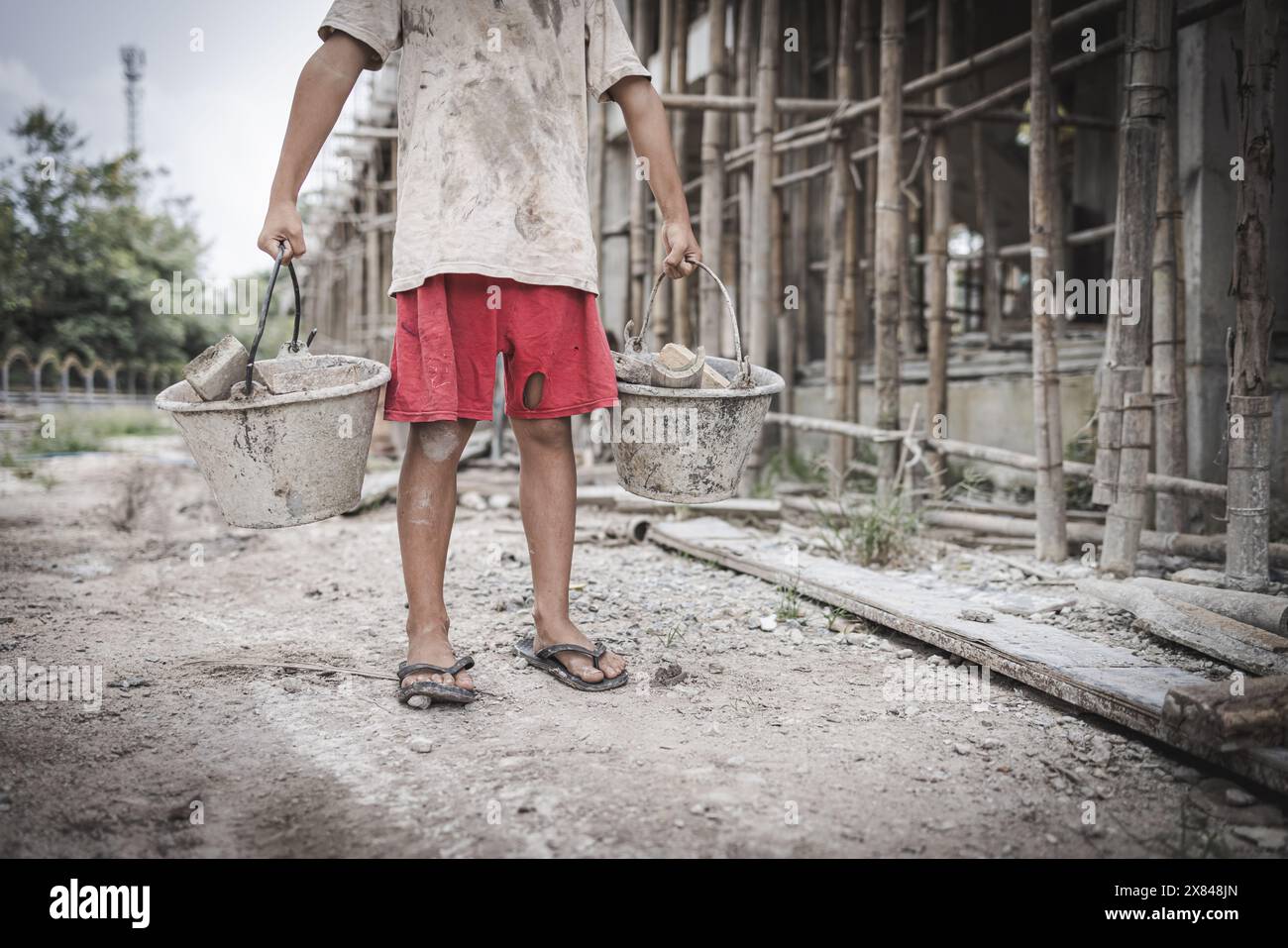 Poor children are forced to work in construction. Poor children ...