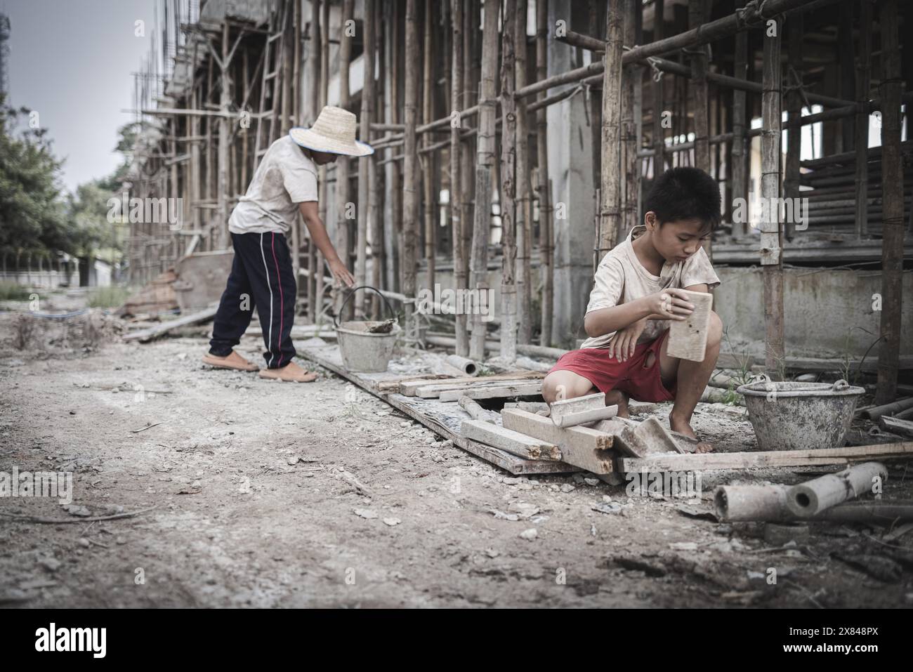Two poor children are forced to work in construction. Poor children ...