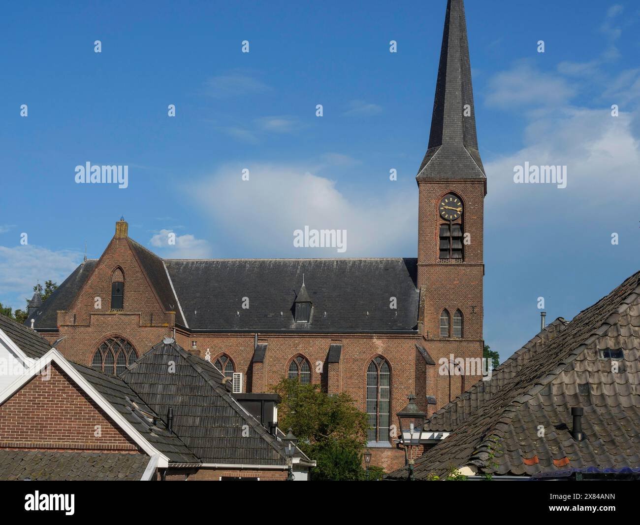 Large church towers over the roofs of the houses in a small town on a ...
