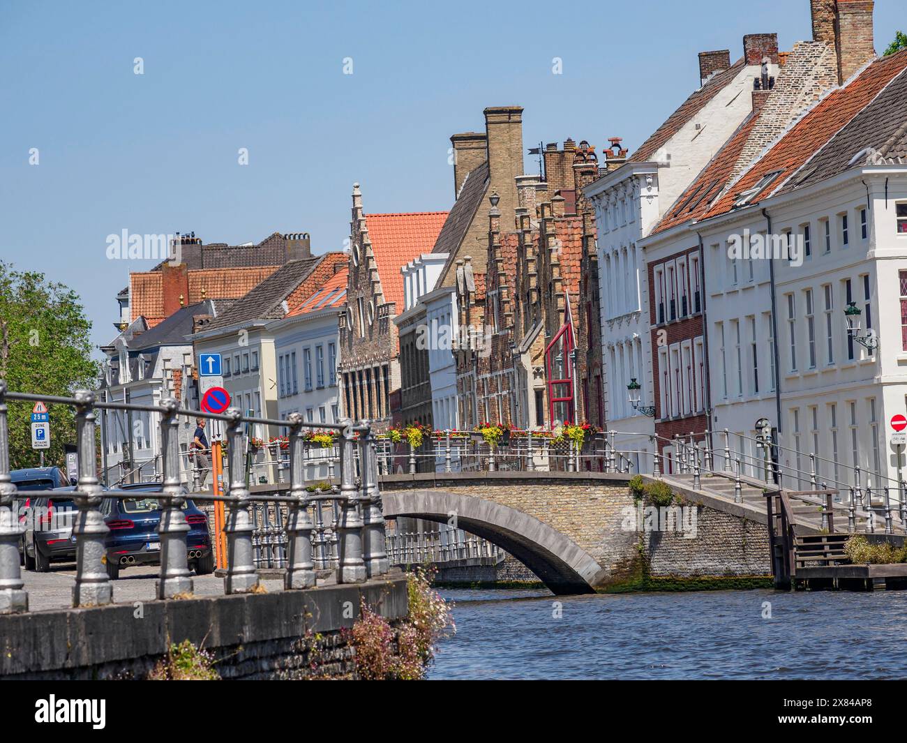 Traditional houses along a canal with a small bridge and sunny sky, old ...