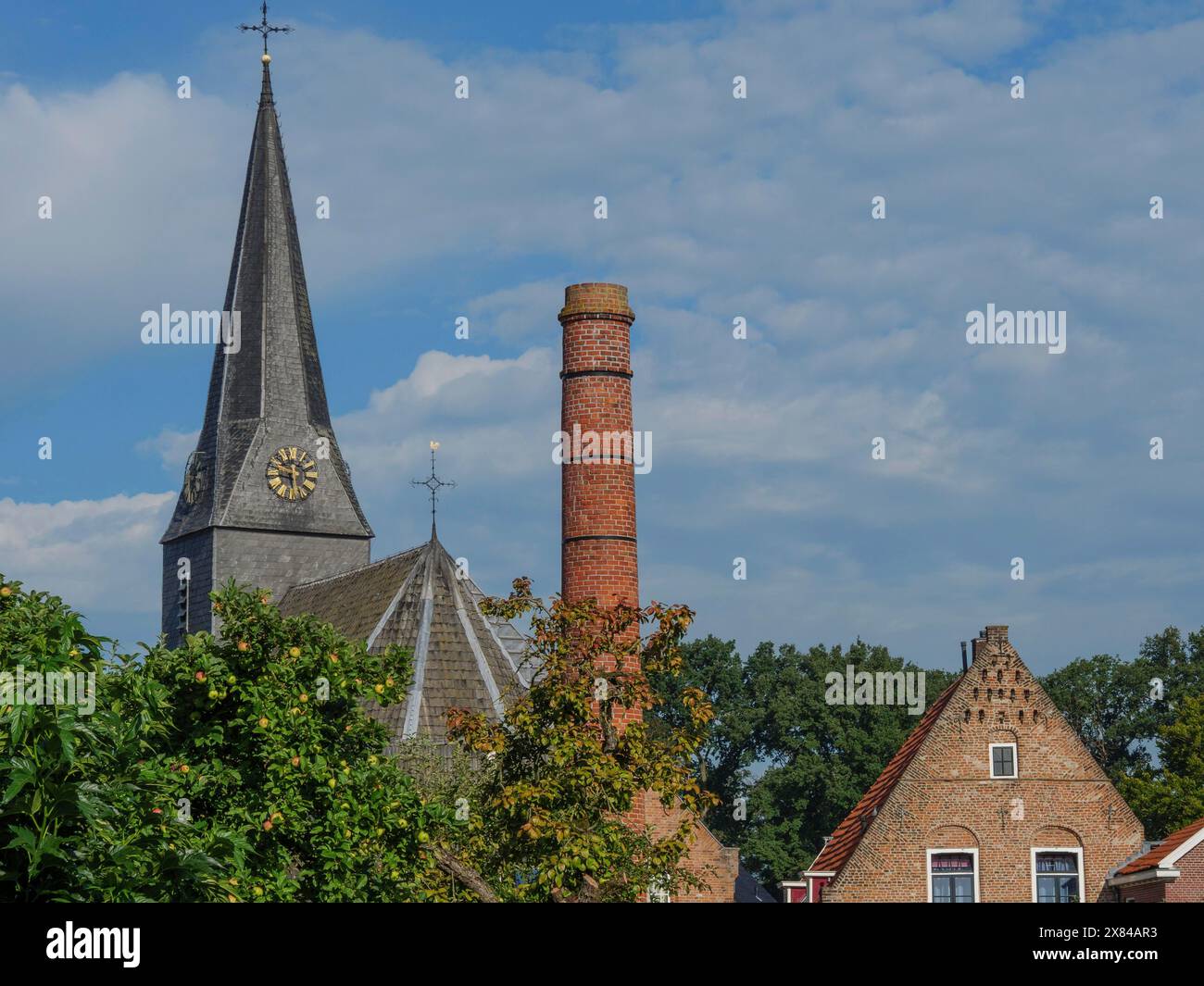 Village view with a church tower, a chimney and traditional brick ...