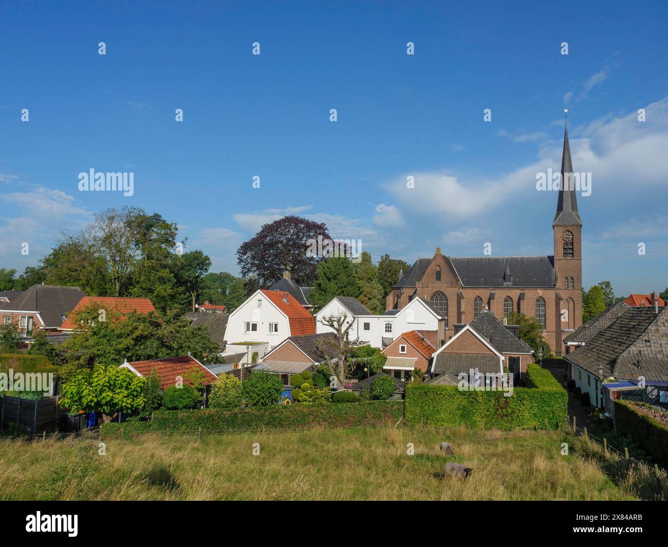 View over a small village with church and traditional houses under a ...