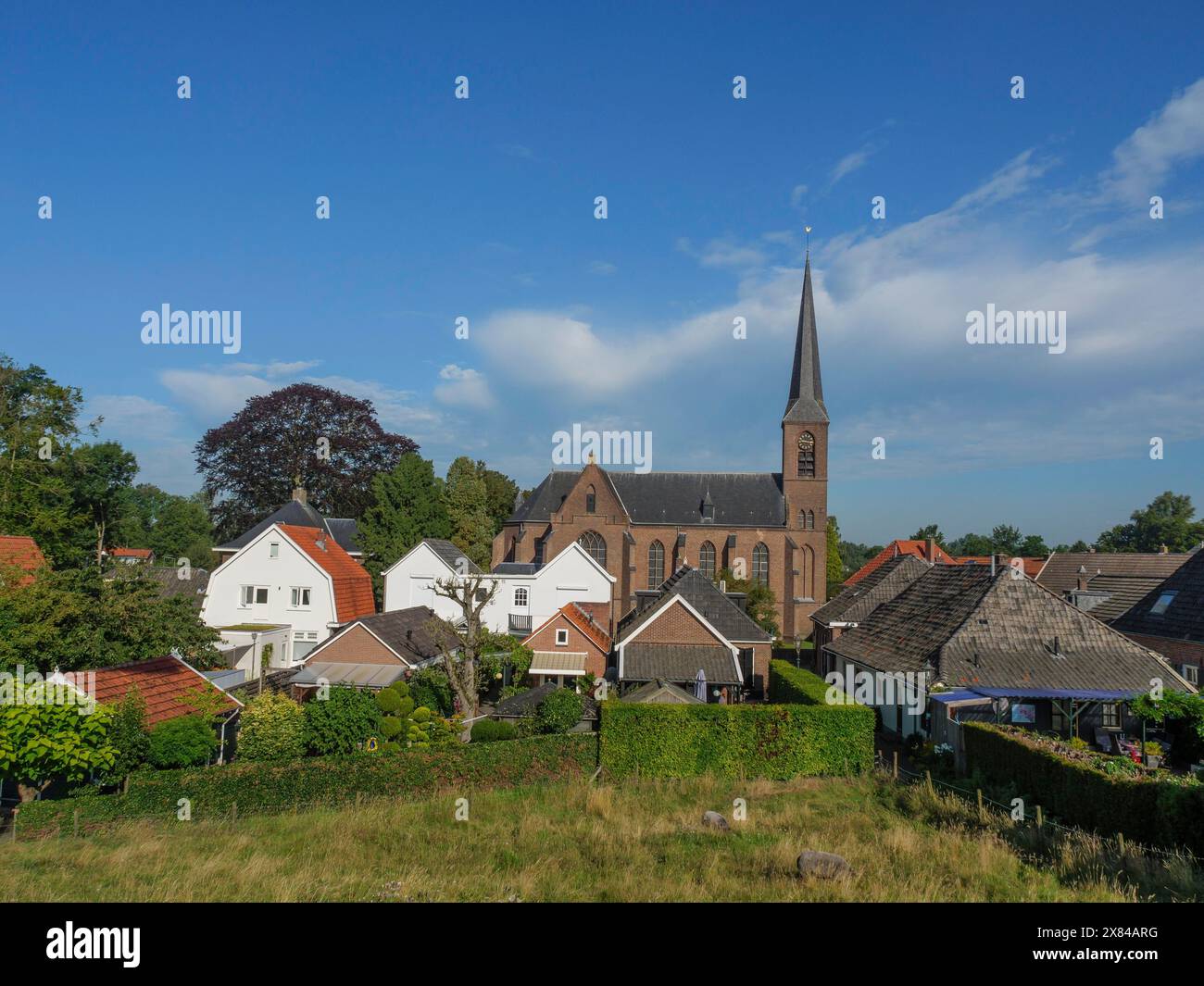 Church and houses in a small village, surrounded by a rural idyll and a ...