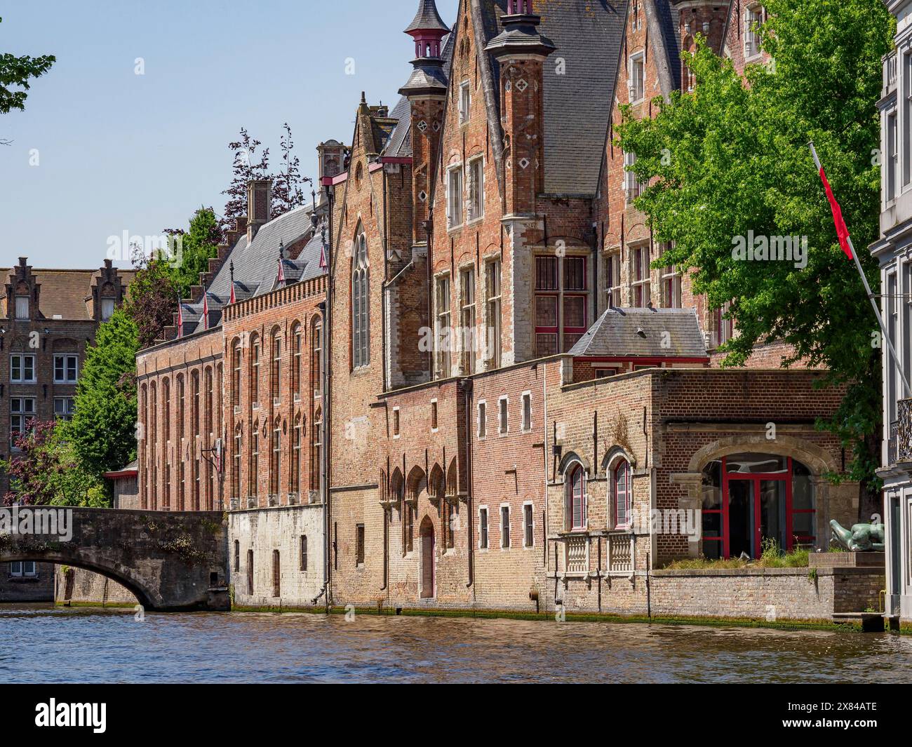 Historic buildings and a stone bridge along a canal, summer atmosphere ...
