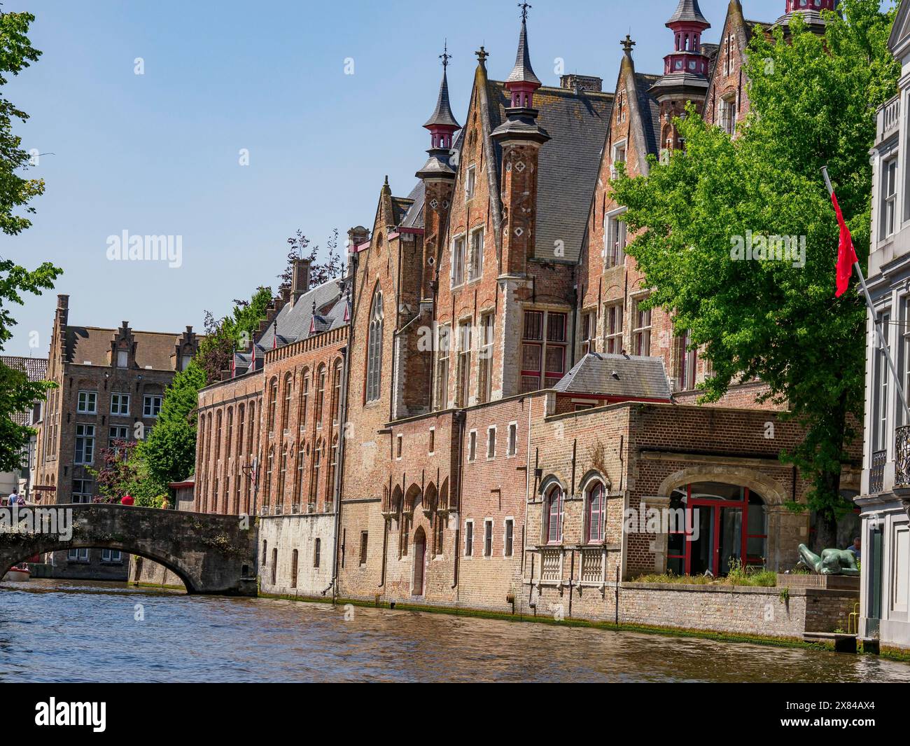 Gothic buildings and a bridge over a quiet canal, surrounded by ...