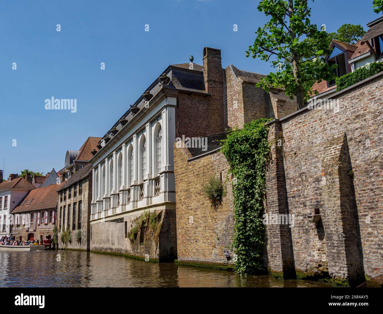 Historic riverside buildings with brick walls and windows under a sunny ...