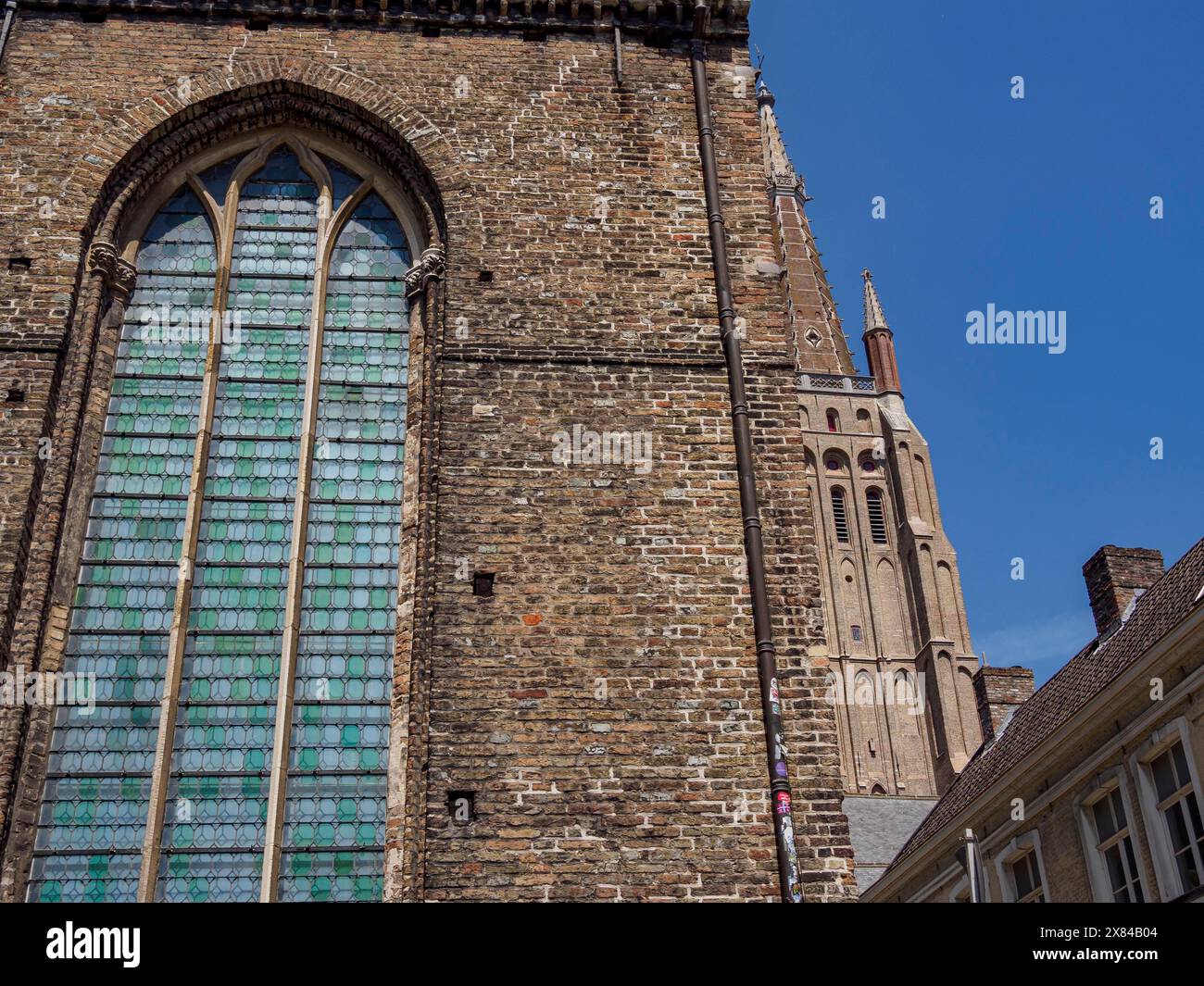 Gothic church with colourful windows and a high tower under a clear ...