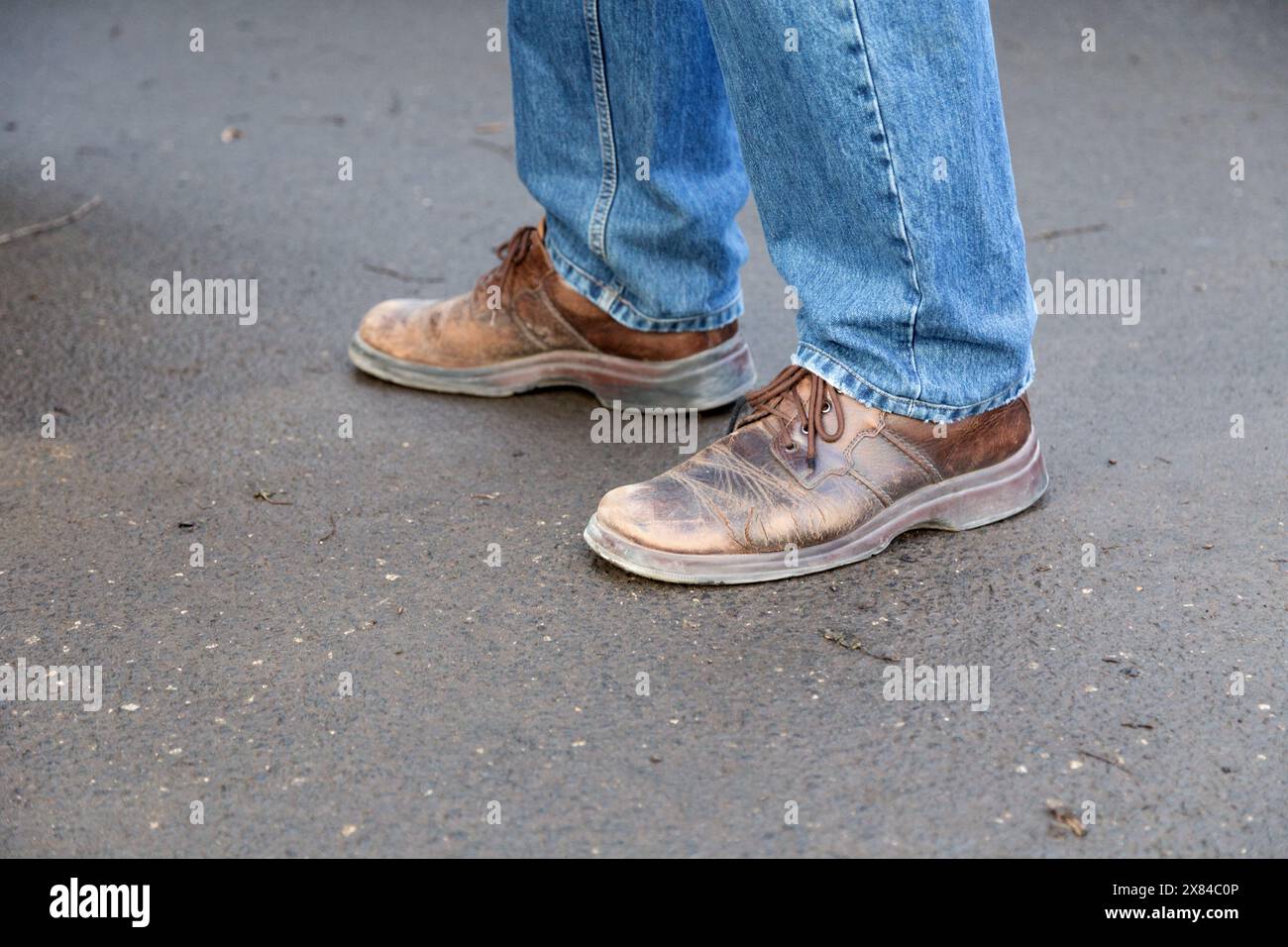 Man's legs in blue denim jeans and brown boots. Close-up Stock Photo ...