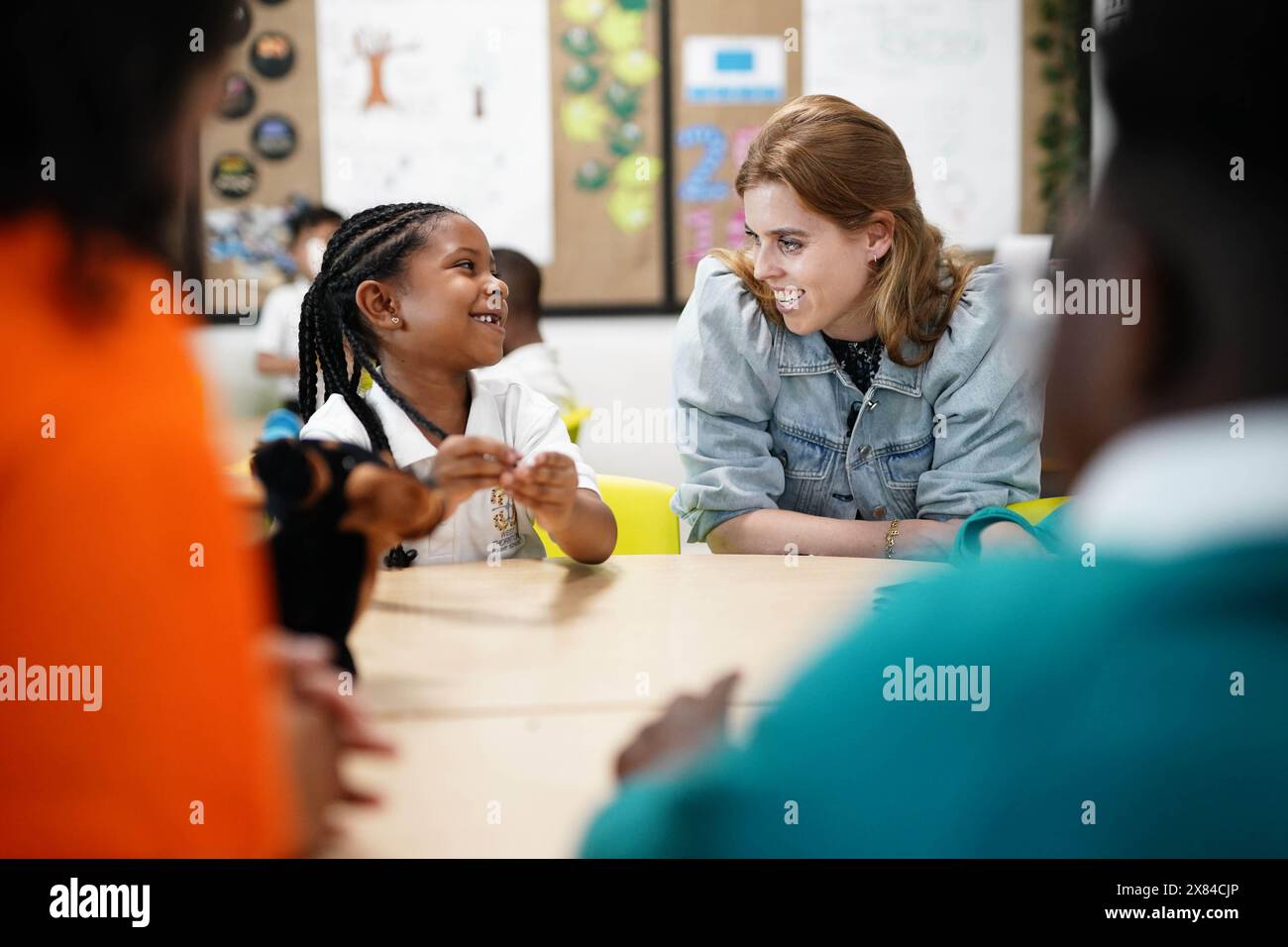 EDITORIAL USE ONLY Princess Beatrice reads to pupils at West Thornton ...