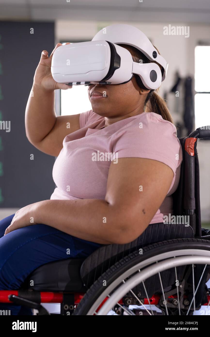 A biracial female paraplegic patient at rehabilitation center, using ...