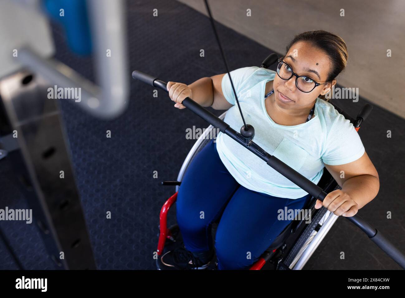 At rehabilitation center, young biracial female paraplegic patient ...