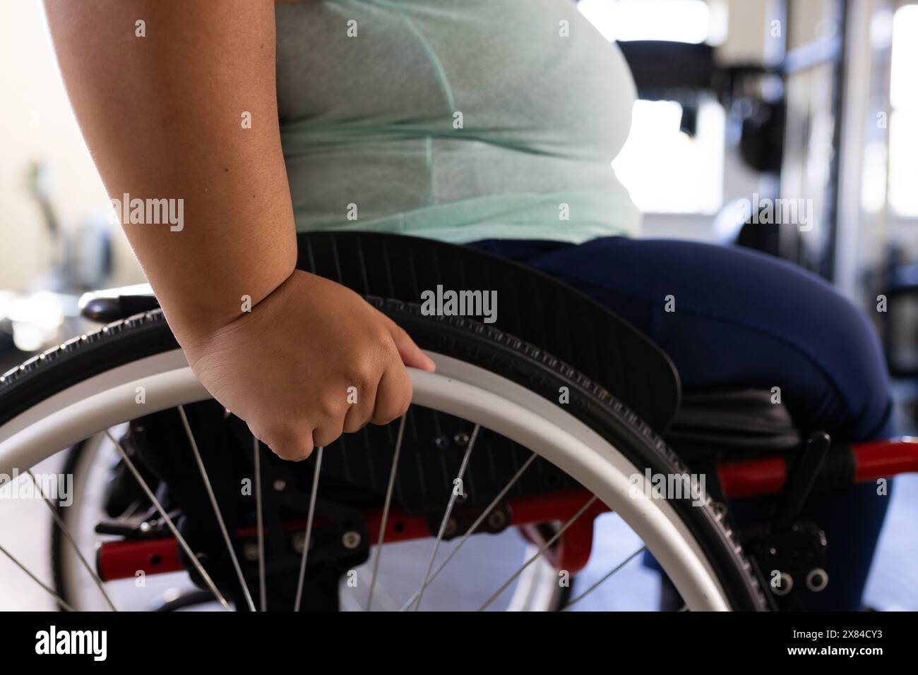 At rehabilitation center, young biracial female paraplegic patient ...