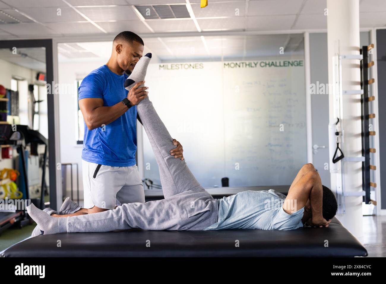 At rehabilitation center, biracial male physical therapist helps ...