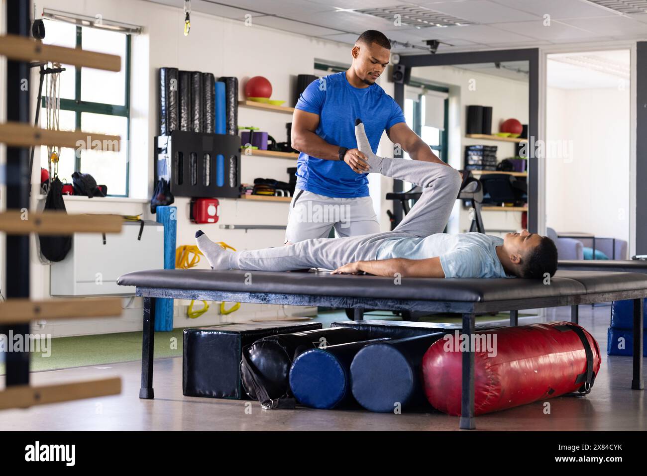 At rehabilitation center, biracial male physical therapist and patient ...