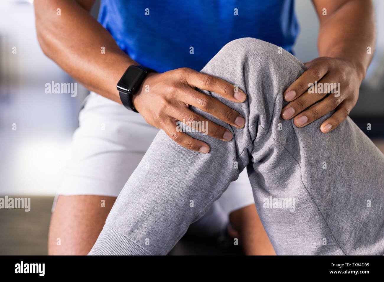 At rehabilitation center, biracial male physical therapist helps ...