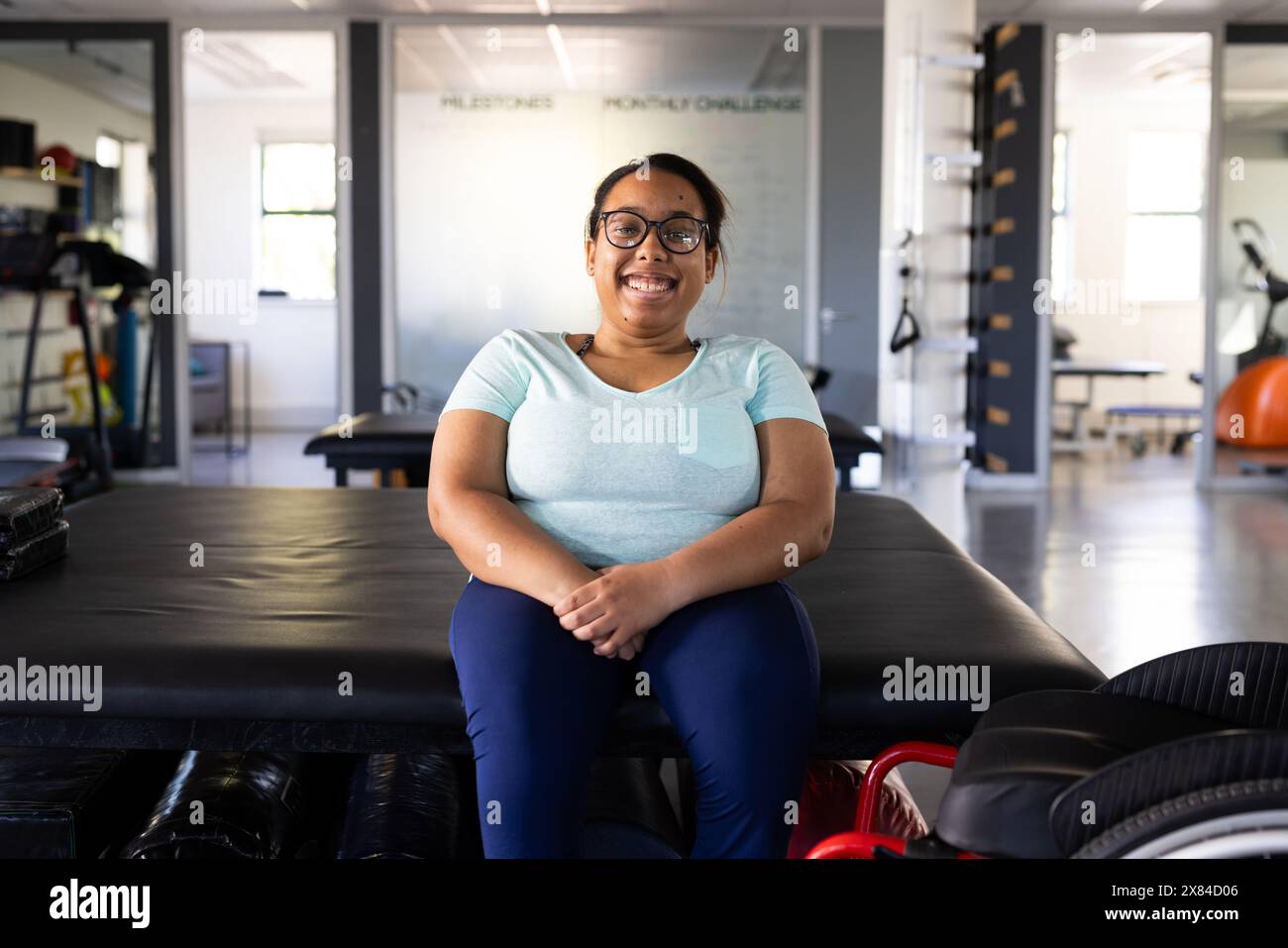 At rehabilitation center, young biracial female paraplegic patient ...