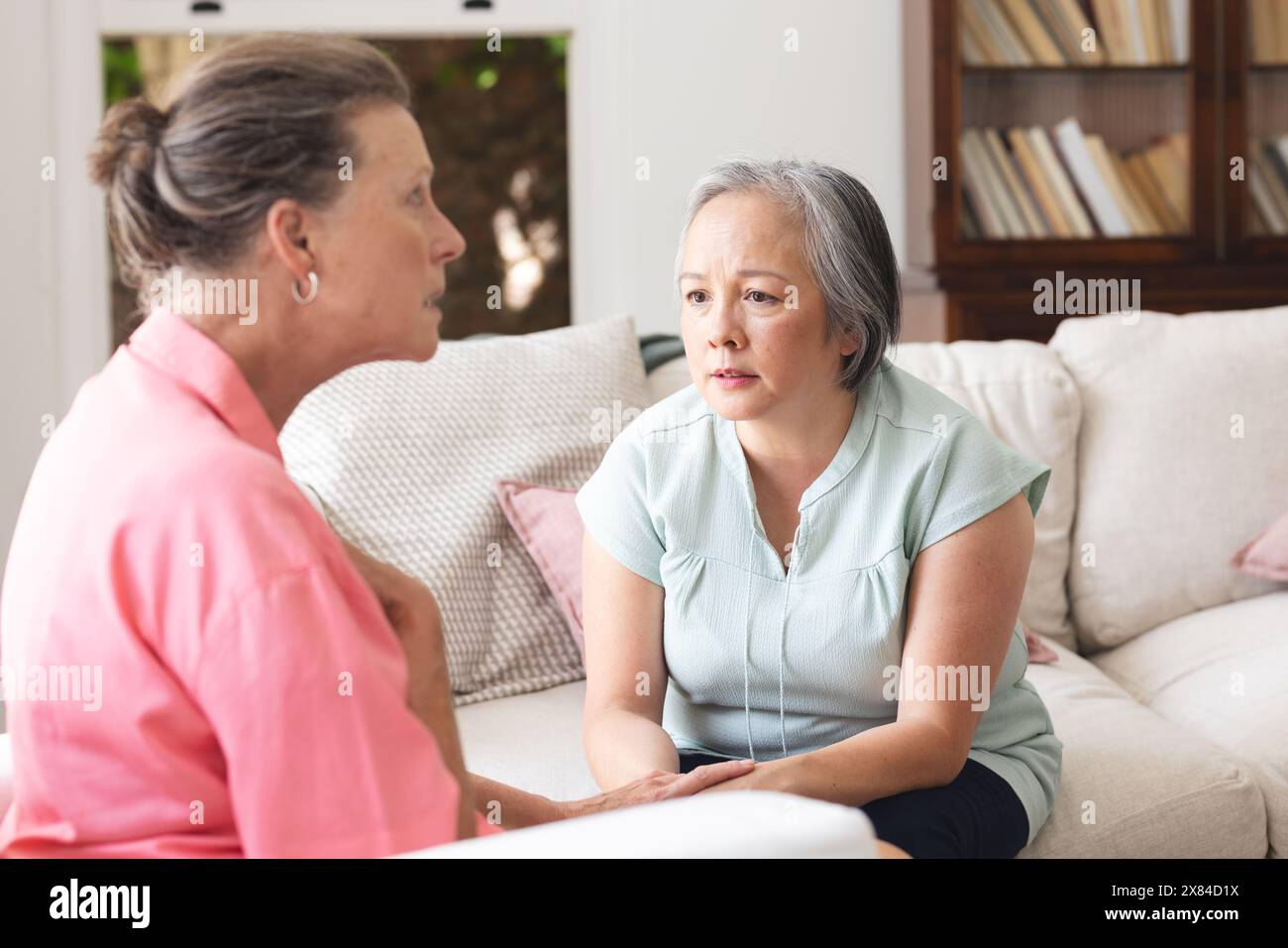 Diverse senior female friends are chatting at home with short hair ...