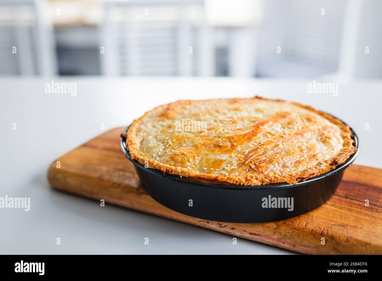 homemade round puff pastry pie in style of a sheperd's pie with sesame ...