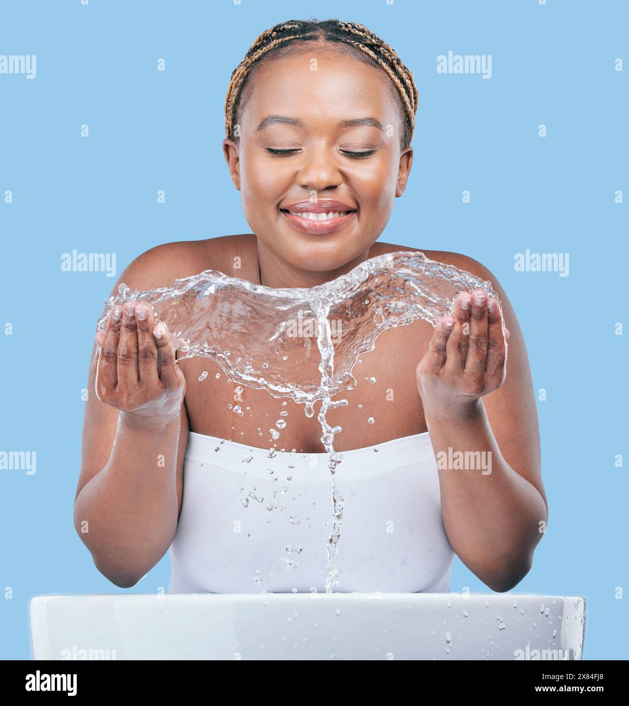 Water splash, skincare and black woman in studio with natural, beauty and facial routine ...