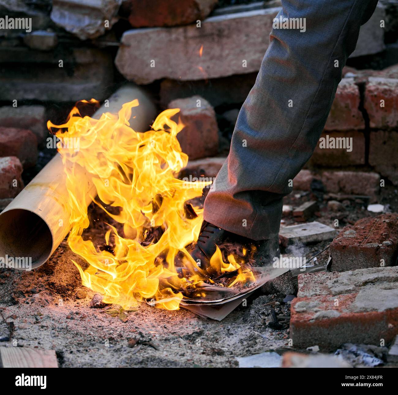 Leg, outdoor and foot of person with fire for accident or emergency ...