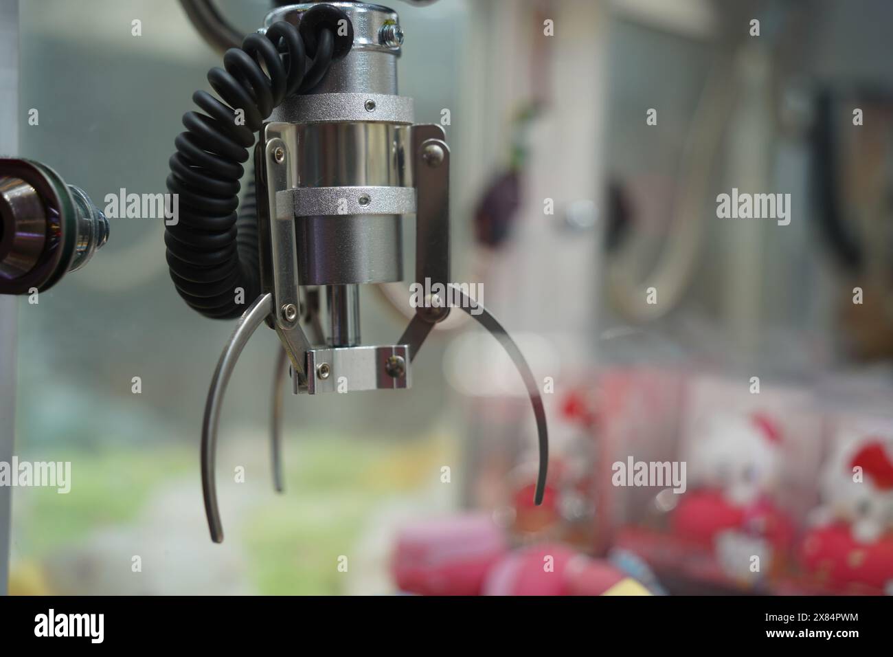 Claws for claw machines in the arcade Stock Photo - Alamy