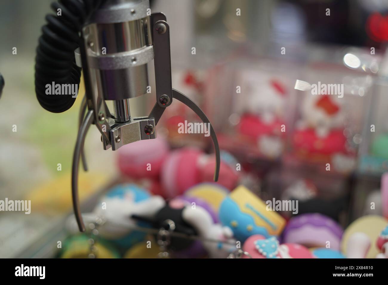 Claws for claw machines in the arcade Stock Photo - Alamy
