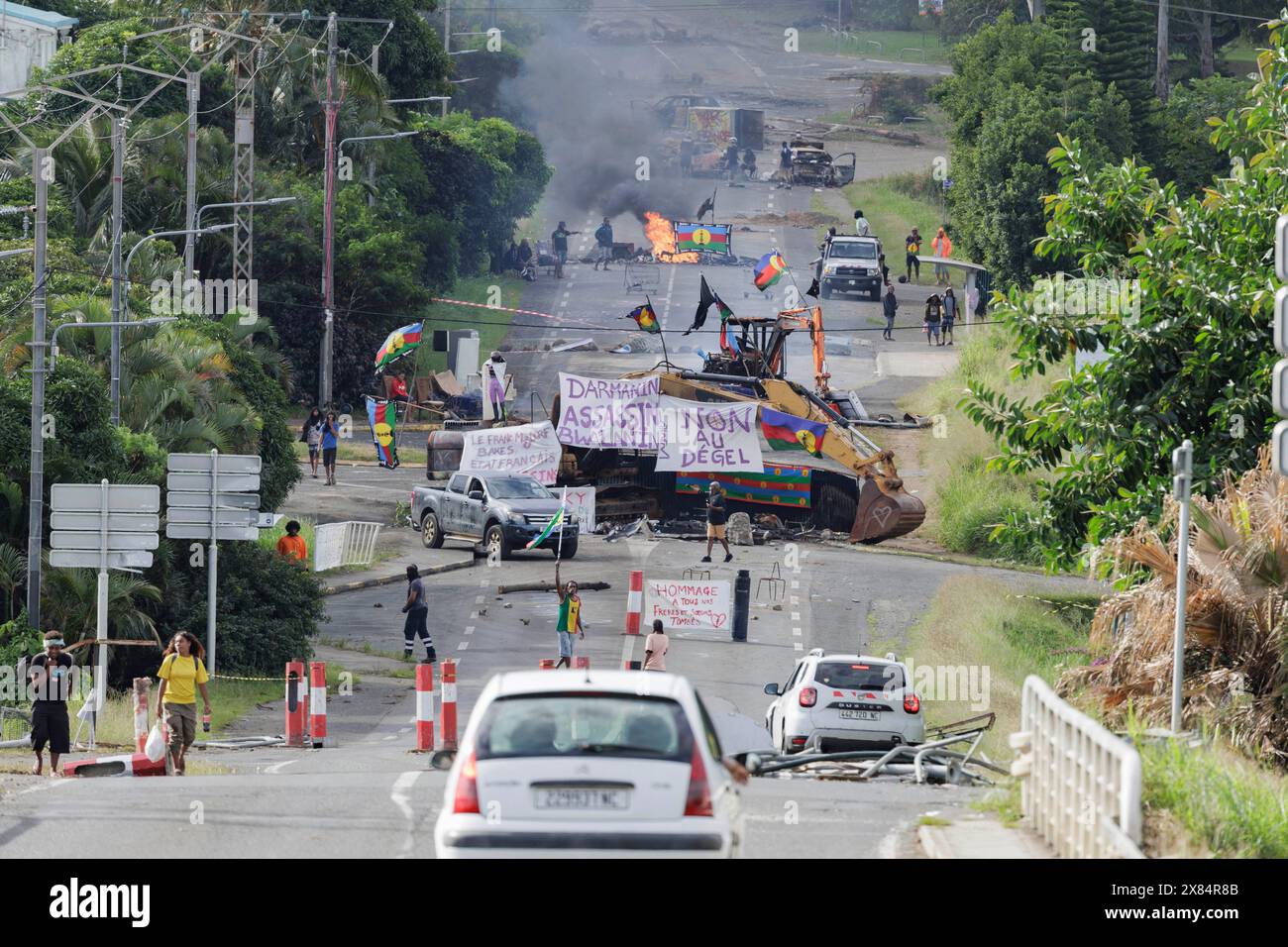 Noumea, France. 23rd May, 2024. Protesters wave Kanak flags at an ...