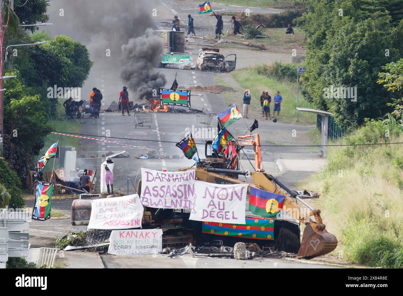 Noumea, France. 23rd May, 2024. Protesters wave Kanak flags at an ...