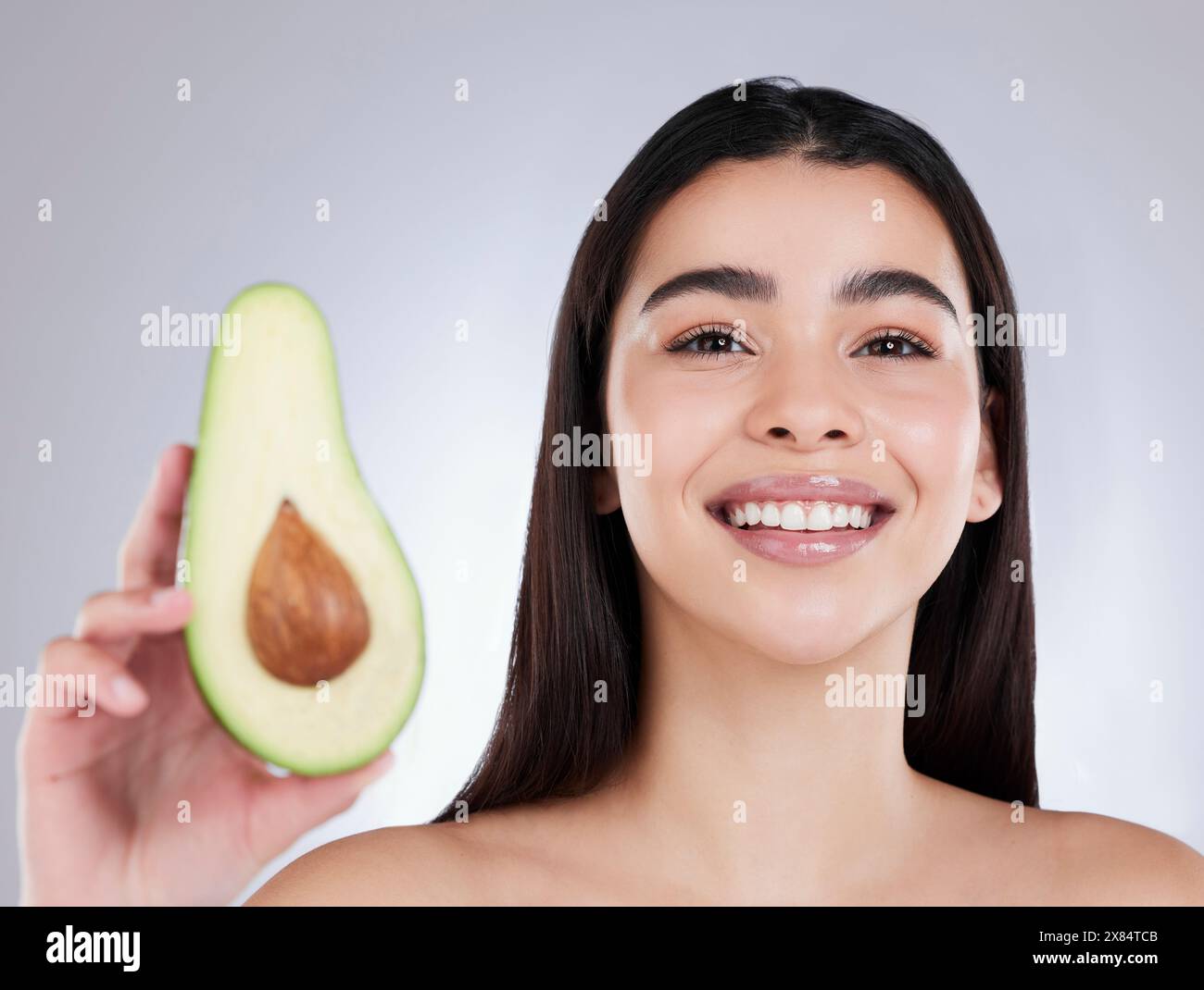 Portrait, avocado and beauty or skincare for woman in studio, nutrition ...