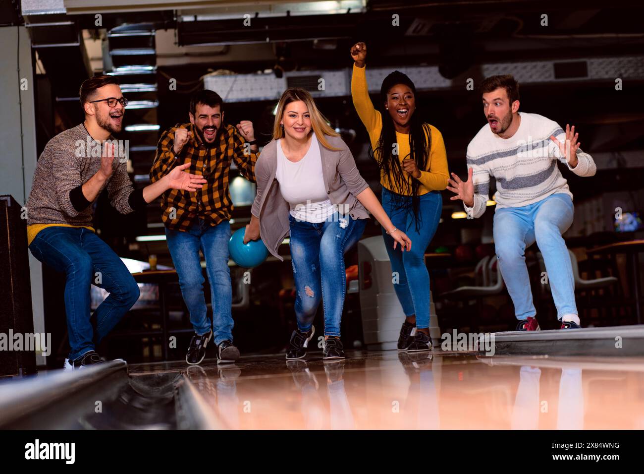 Group of friends enjoying time together laughing and cheering while ...