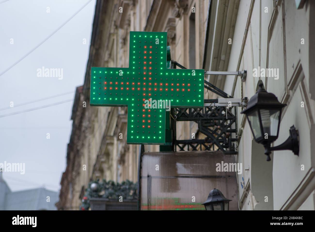 pharmacy shop running sign cross green glowing at home Stock Photo - Alamy